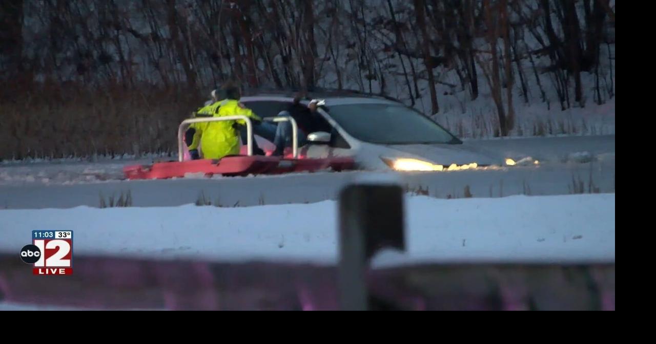 Flint firefighters rescue driver from partially frozen pond | Local ...