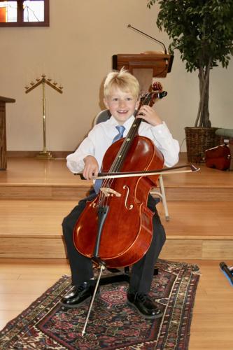 guy playing cello in tree