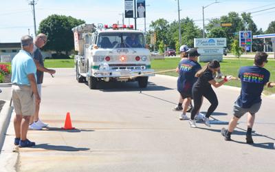 people pulling trucks