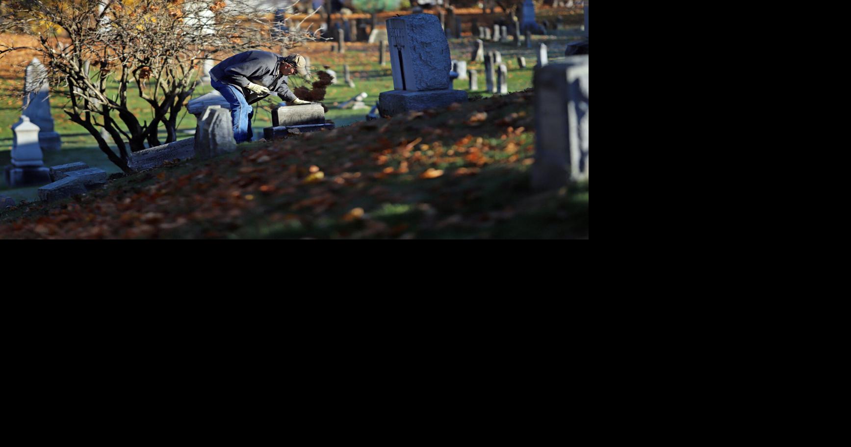 'This is our history': Volunteers help fix tombstones after vandalism ...
