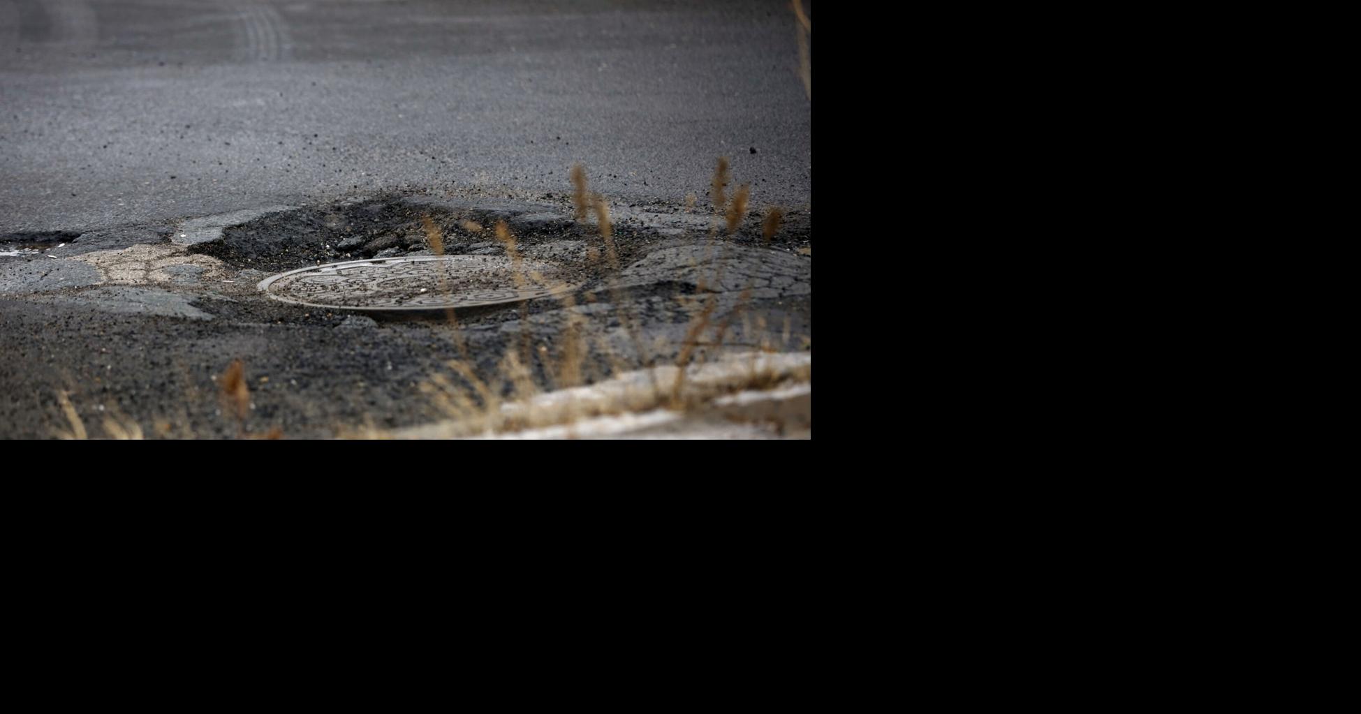 large pothole around manhole cover | | berkshireeagle.com