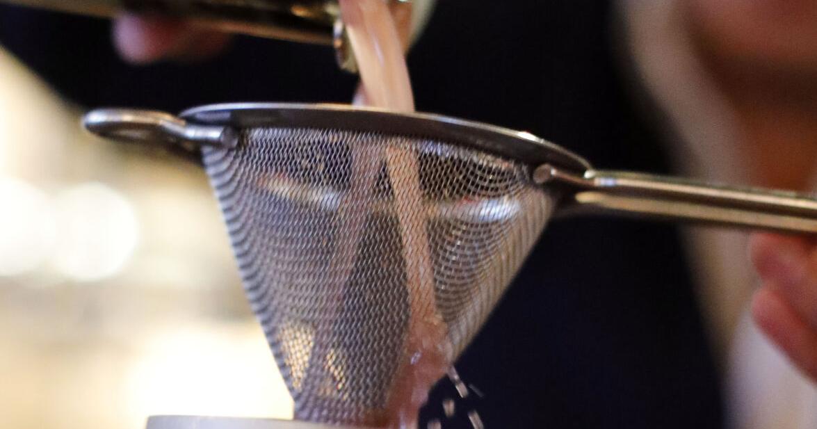 bartender straining drink from shaker into glass | | berkshireeagle.com