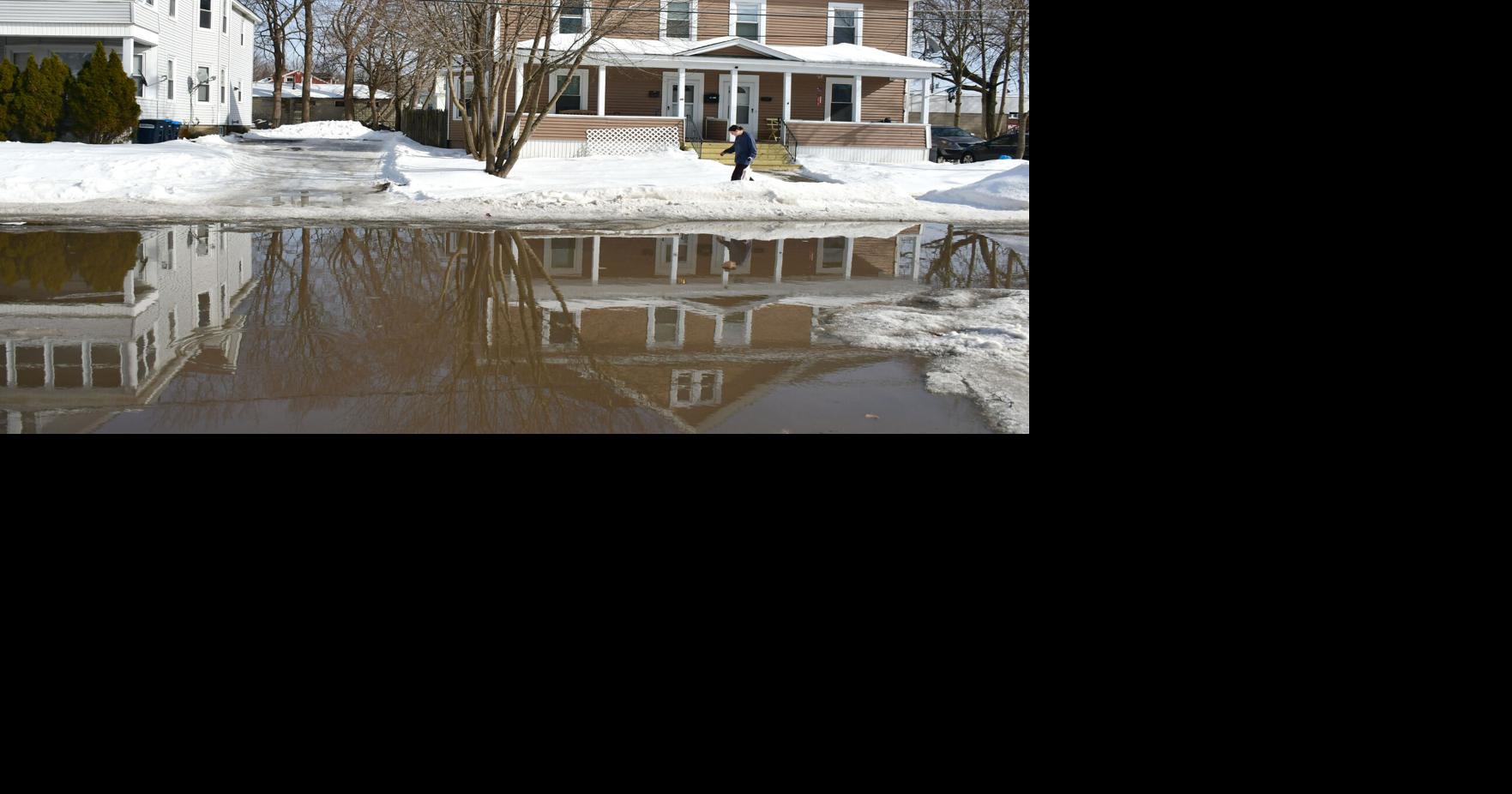 A woman is reflected in a puddle as she walks | | berkshireeagle.com