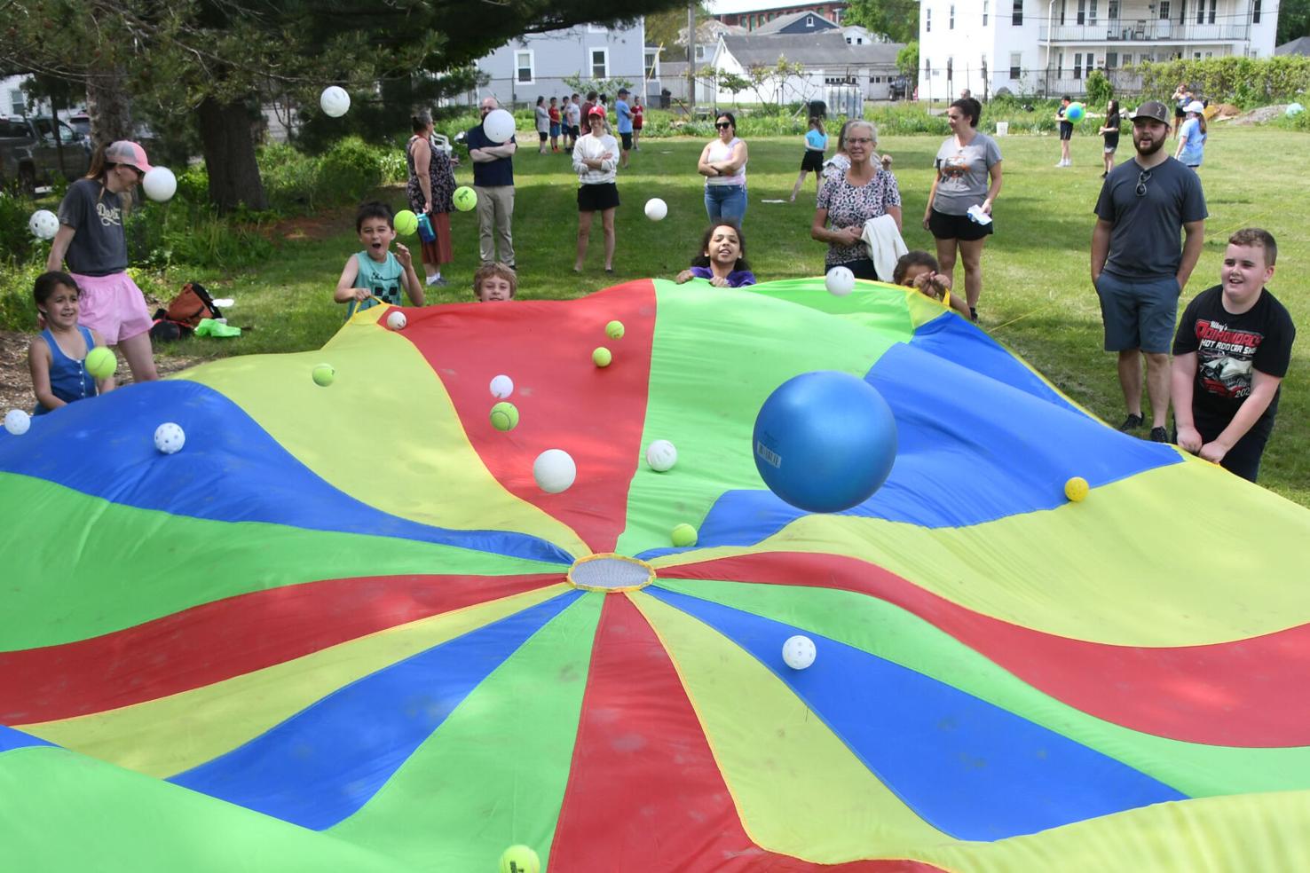 Kids do a parachute game with balls | | The Berkshire Eagle