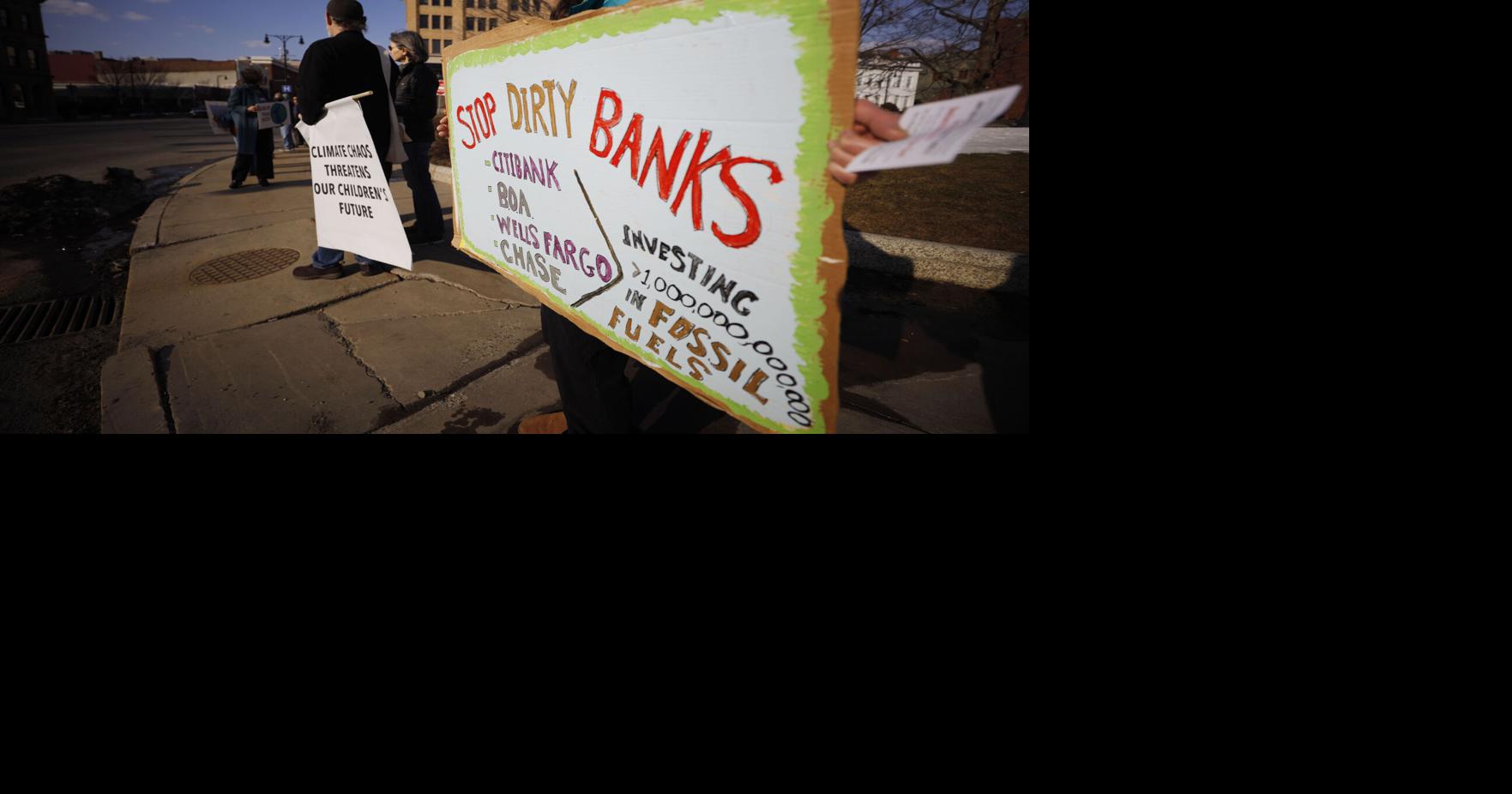 Photos: Climate action group protests big banks for their investment in ...