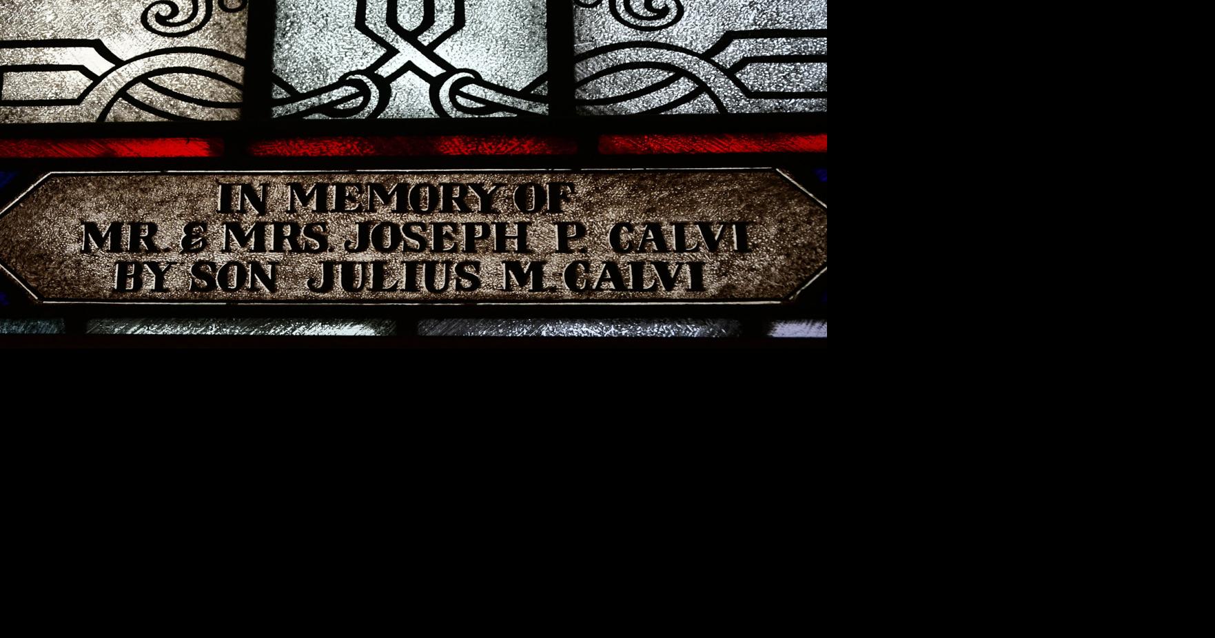 An inscription at the bottom of a stained glass window ...