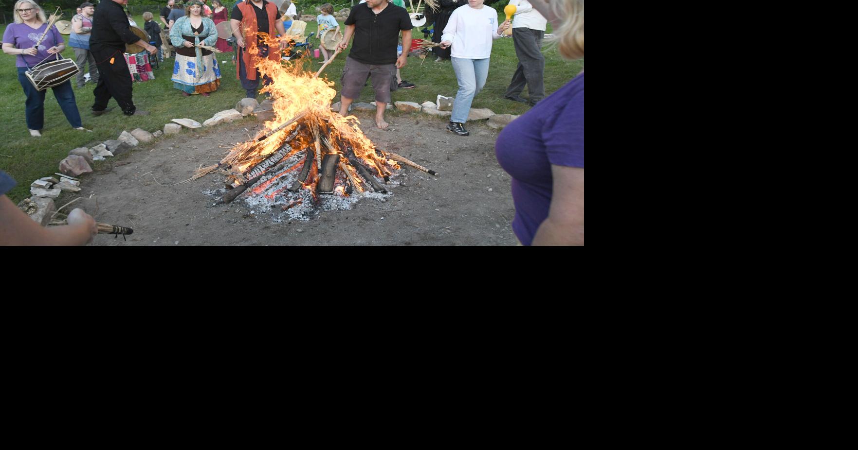 Revelers dance around a fire | | The Berkshire Eagle