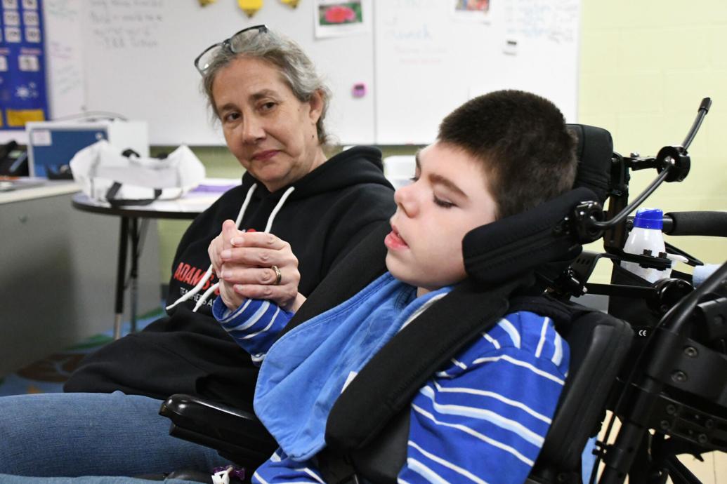 A woman holds the hand of a child in a wheelchair | | The Berkshire Eagle