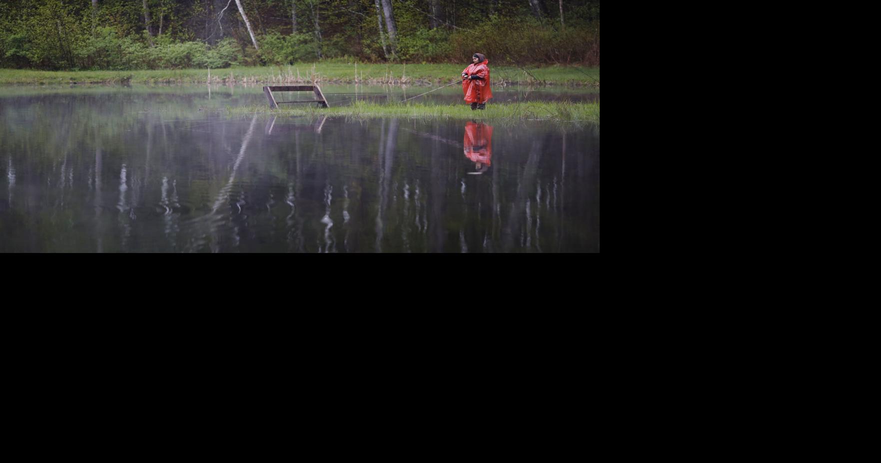 girl in red poncho fishing | | The Berkshire Eagle