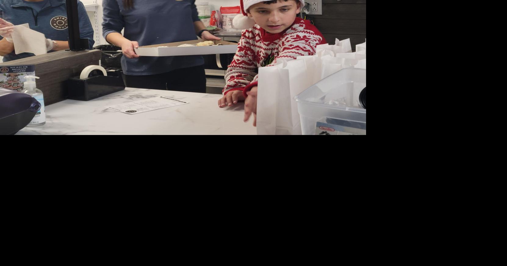 Nate Sykes behind the counter at Shire Donuts | | berkshireeagle.com
