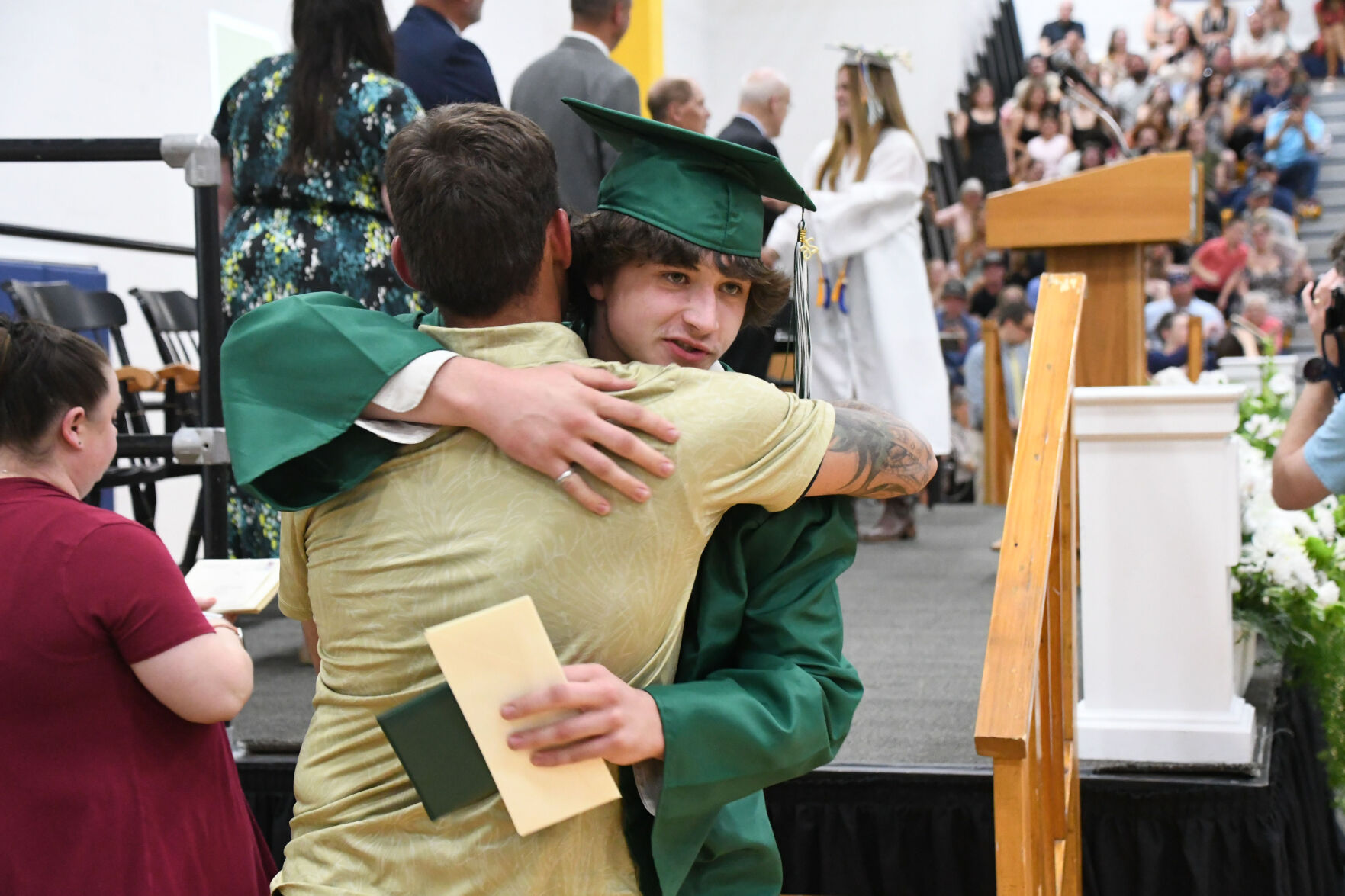 A graduate is embraced by his instructor | | The Berkshire Eagle