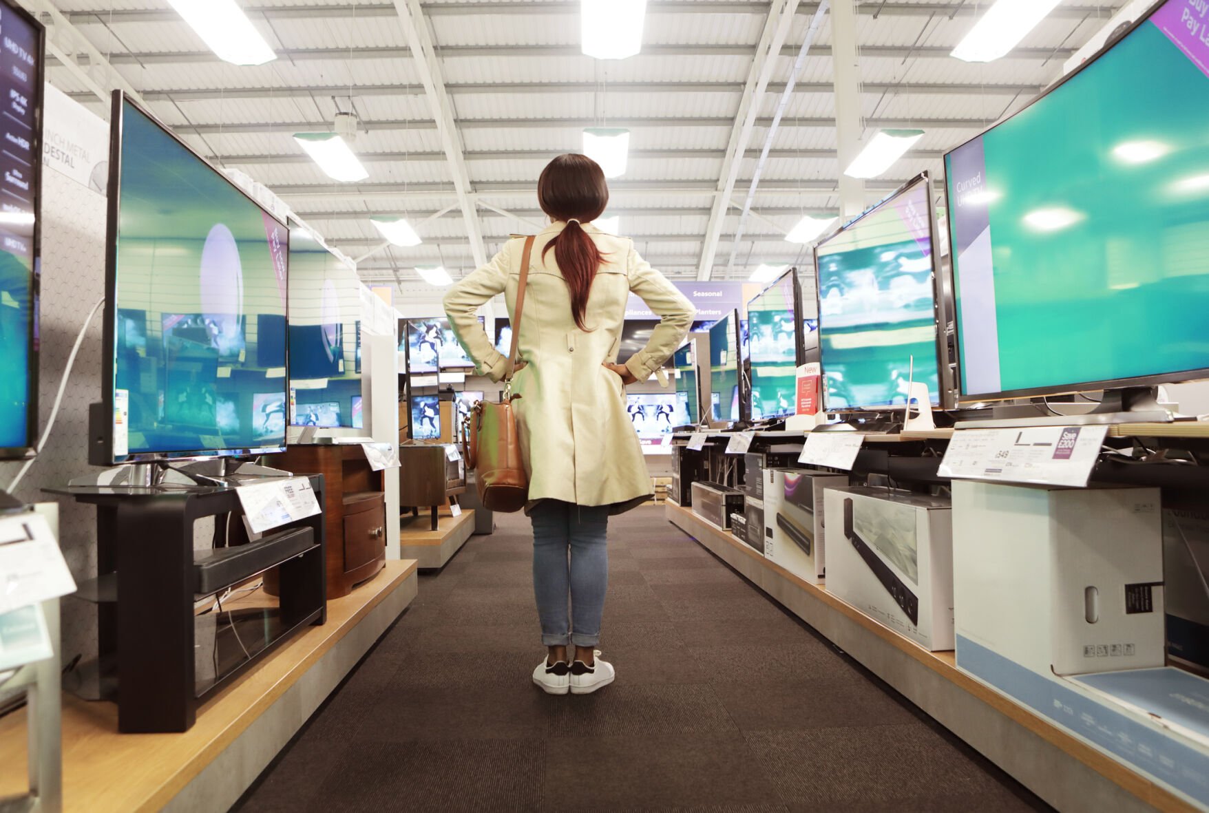Young woman in shop looking at televisions | | berkshireeagle.com