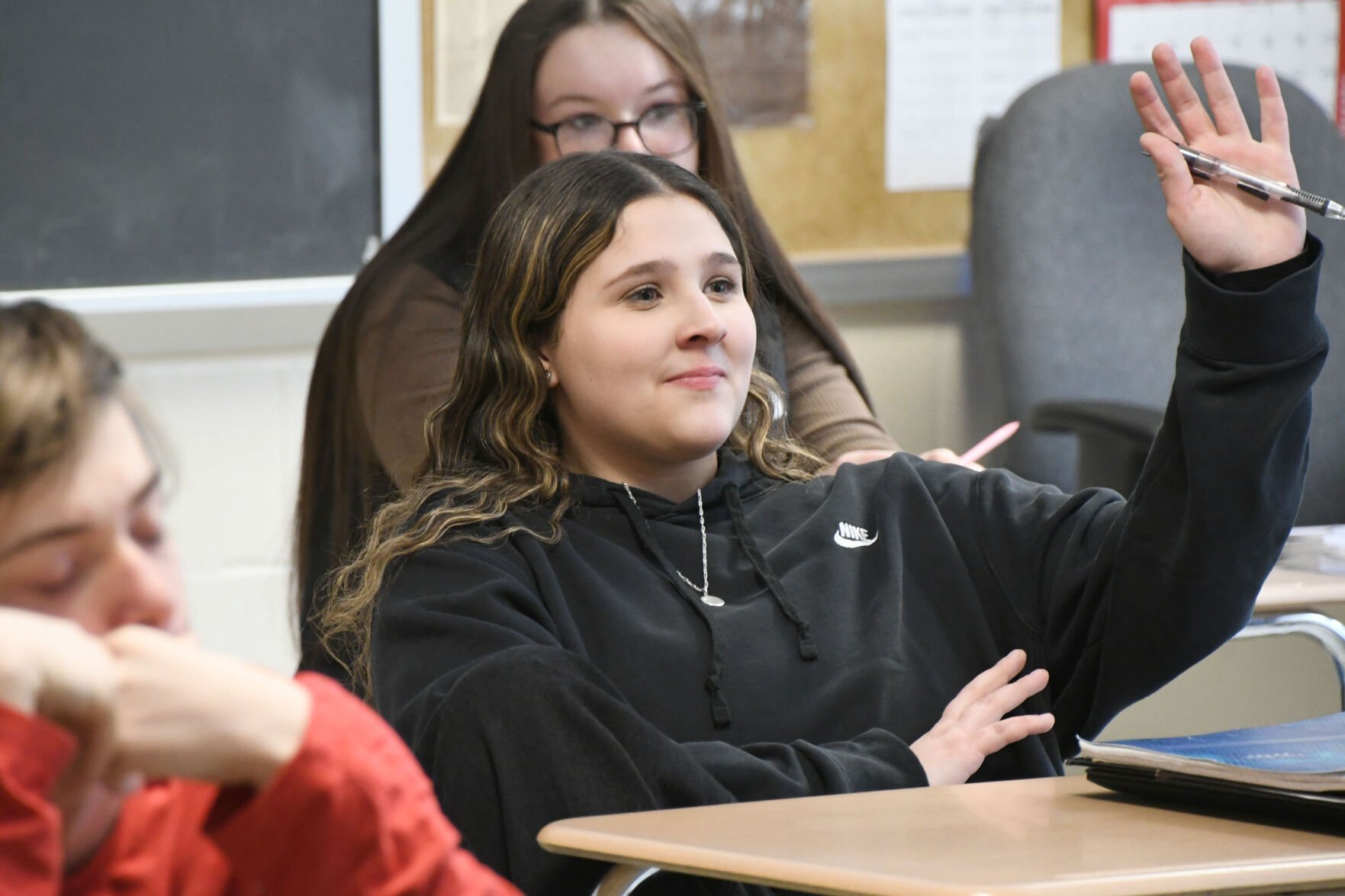 Student in a classroom raises her hand | | berkshireeagle.com