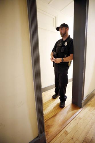 police officer leaning against wall in hallway | | berkshireeagle.com