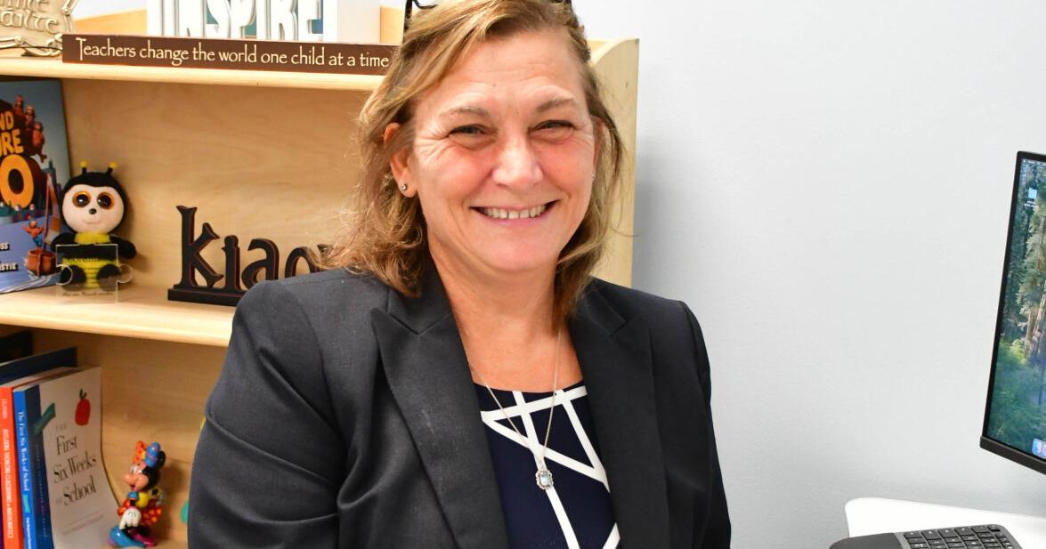A woman poses next to a standing desk | | berkshireeagle.com