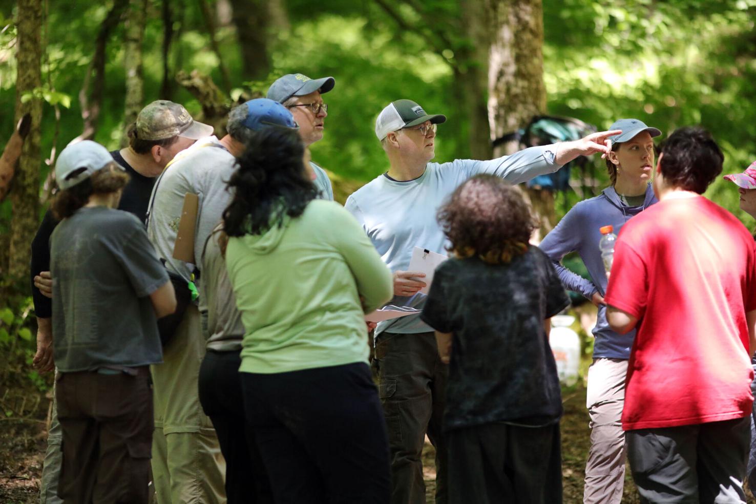 Matt Kirk pointing in group of researchers | | The Berkshire Eagle