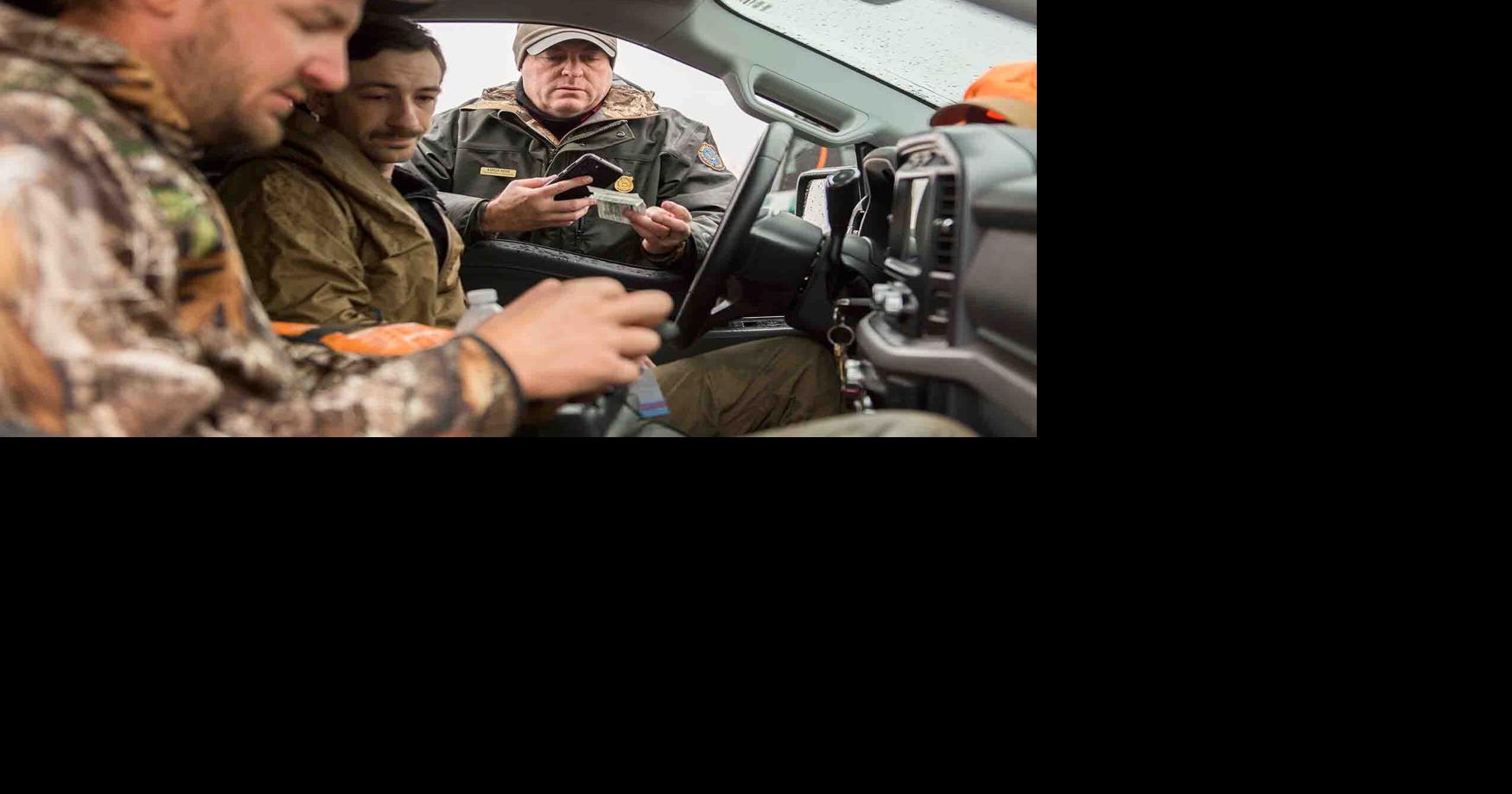 Aaron Kerr, law enforcement supervisor, checks hunter license ...