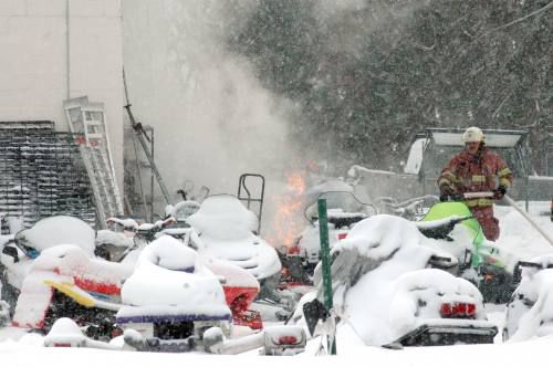 Man injured pushing burning snowmobile out of building | Local News ...