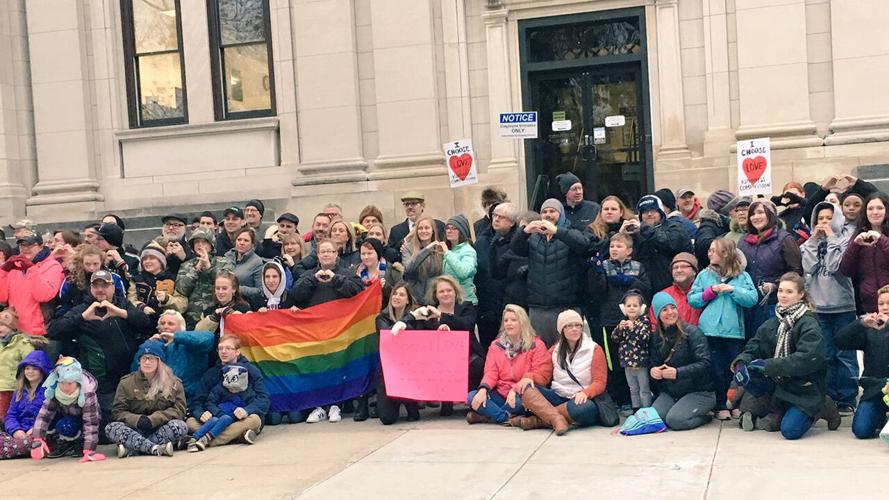 Baraboo community protests hateful photo by posing with symbols of love ...