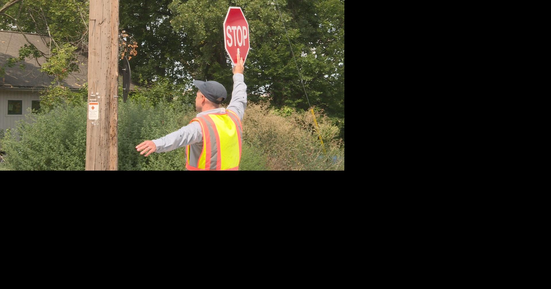 Crossing guard trainee holds up stop sign | | channel3000.com