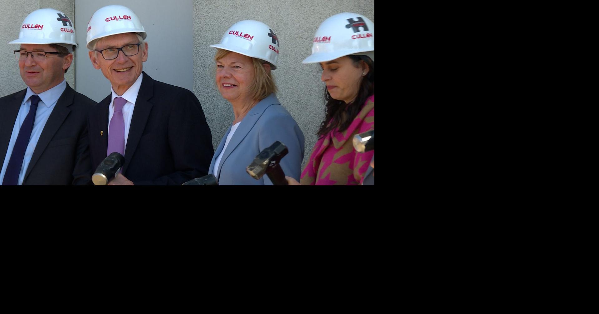 U.S. Sen. Baldwin and Gov. Evers wear JP Cullen hardhats to symbolize Woodman's Center ...