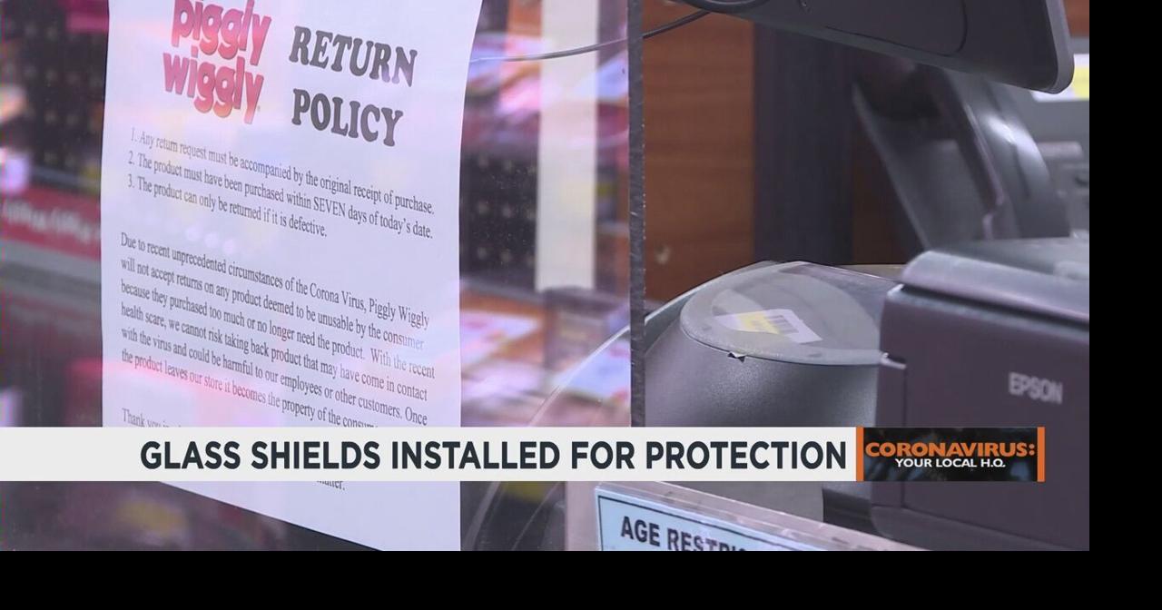 Grocery stores install glass barrier between cashier and customer for ...