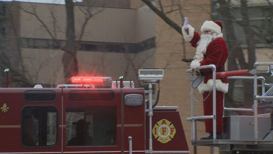 Santa Claus spreads holiday cheer with fire truck parade past American ...