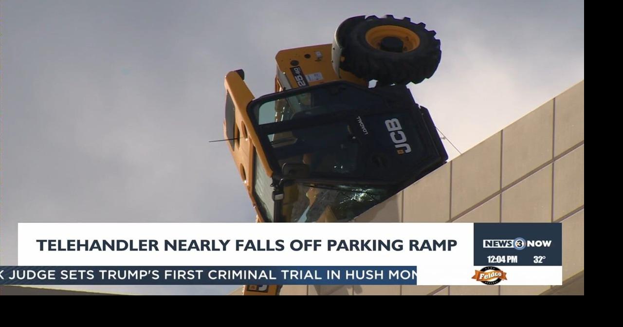Equipment clearing snow tips over edge of parking ramp | Video ...