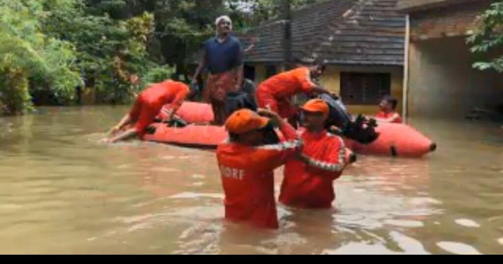 Rescue teams wade through filthy waters to help Kerala flood victims ...