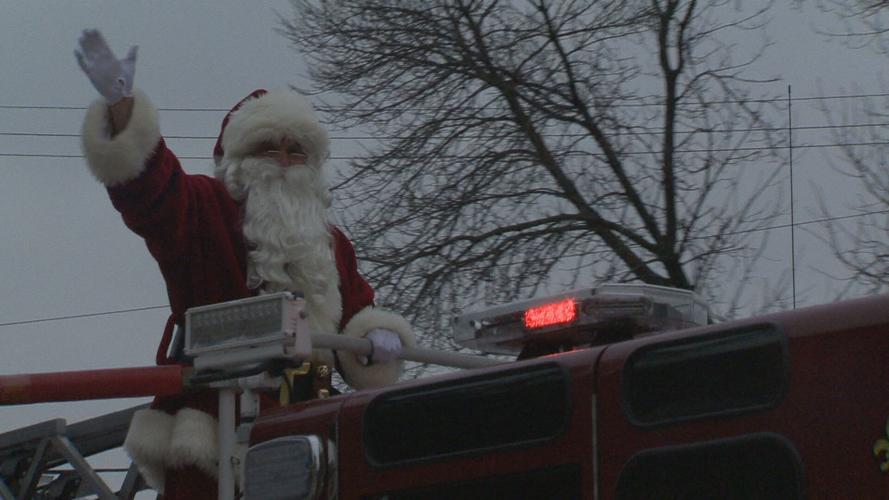Santa Claus spreads holiday cheer with fire truck parade past American ...