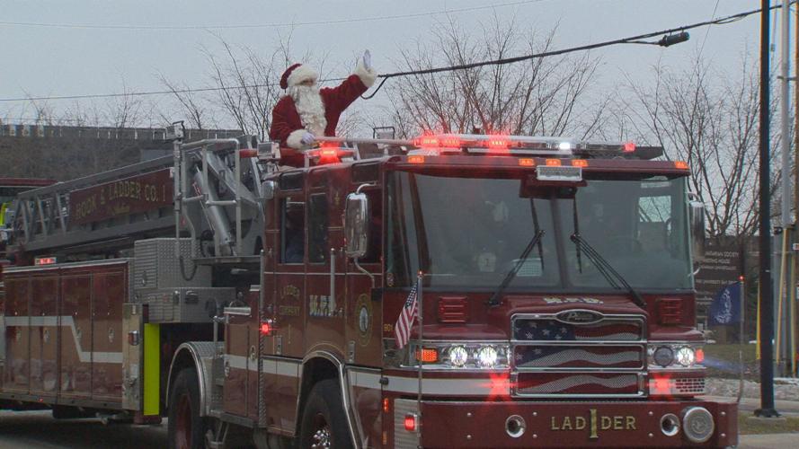 Santa Claus spreads holiday cheer with fire truck parade past American ...