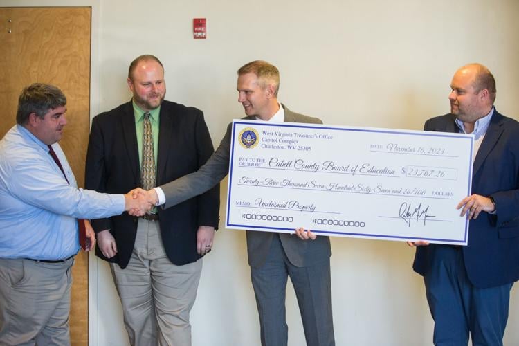 State Treasurer Riley Moore presents unclaimed property checks to local ...