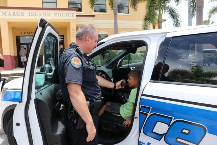 Local Children Enjoy Coloring With a Cop | | coastalbreezenews.com