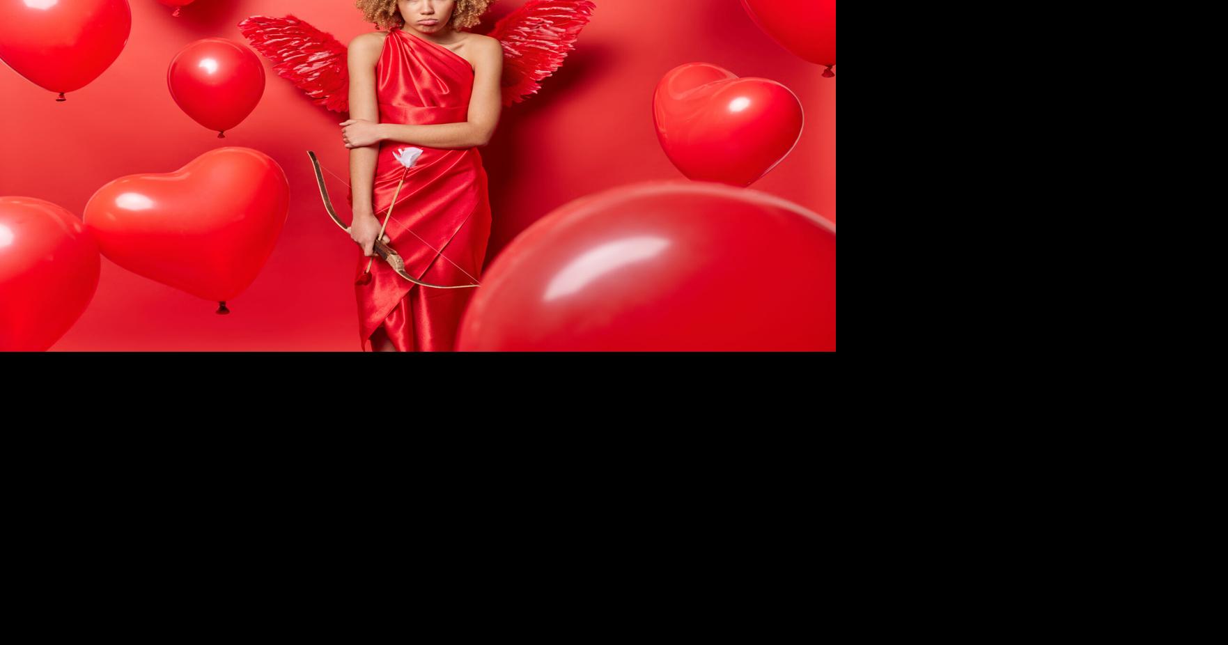 Sad unhappy woman pretends being cupid angel holds bow and arrow looks ...