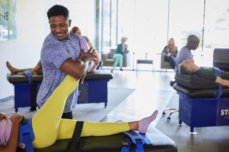 Got back pain? Try some practitioner-assisted stretching | Live Well ...