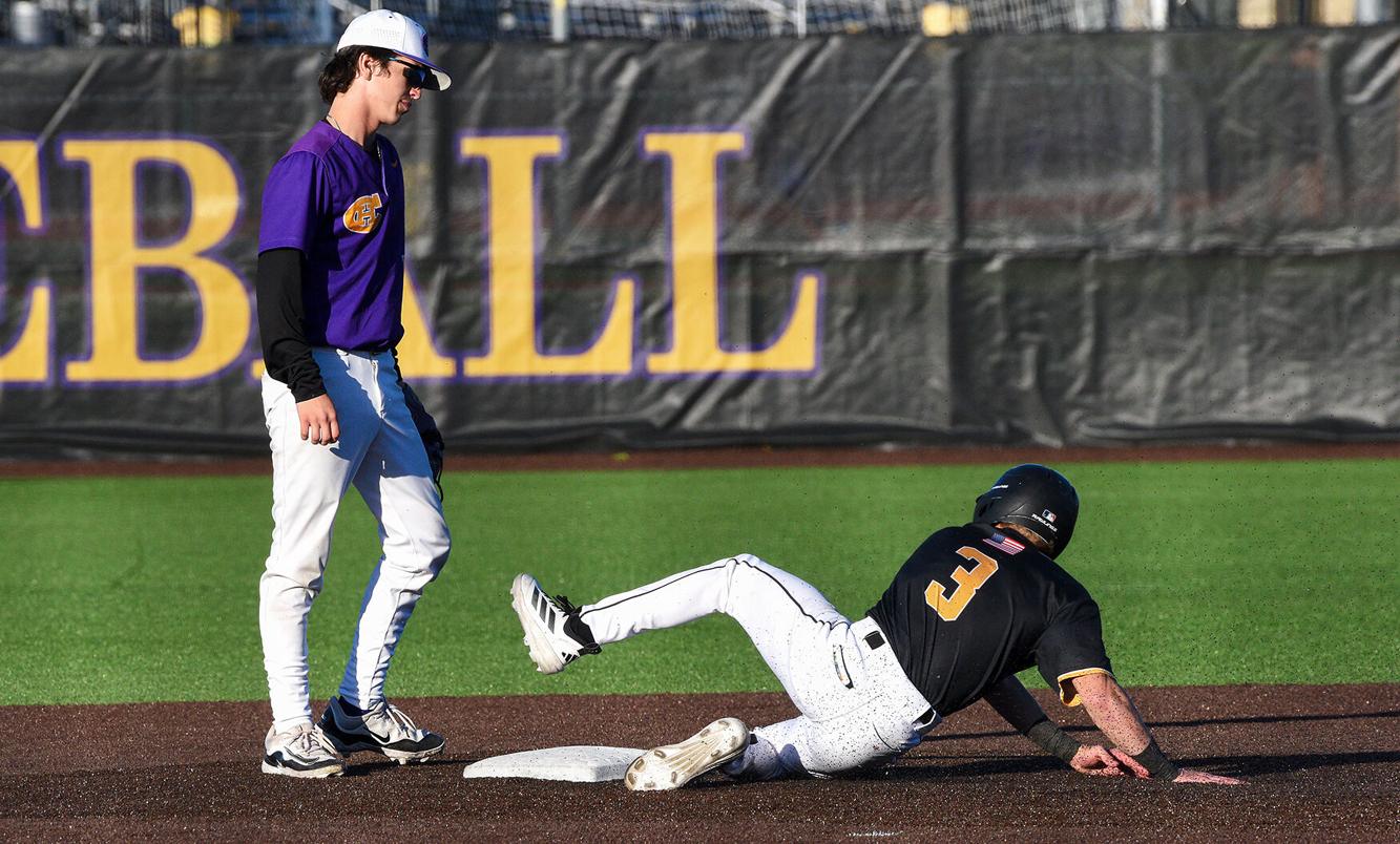 Hickman’s Kolton Crane (5) watches as Ian Jackson (3) slides into ...