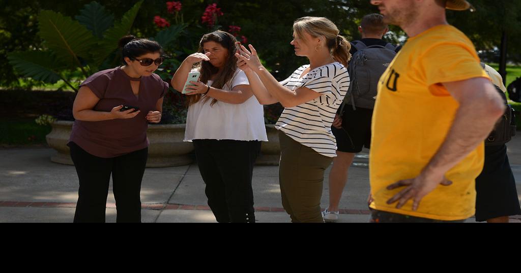 From left, Natalie Taylor, Lacy King and Micah Carson take pictures of ...