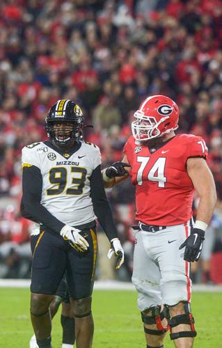 Missouri defensive lineman Tre Williams stands next to Georgia ...