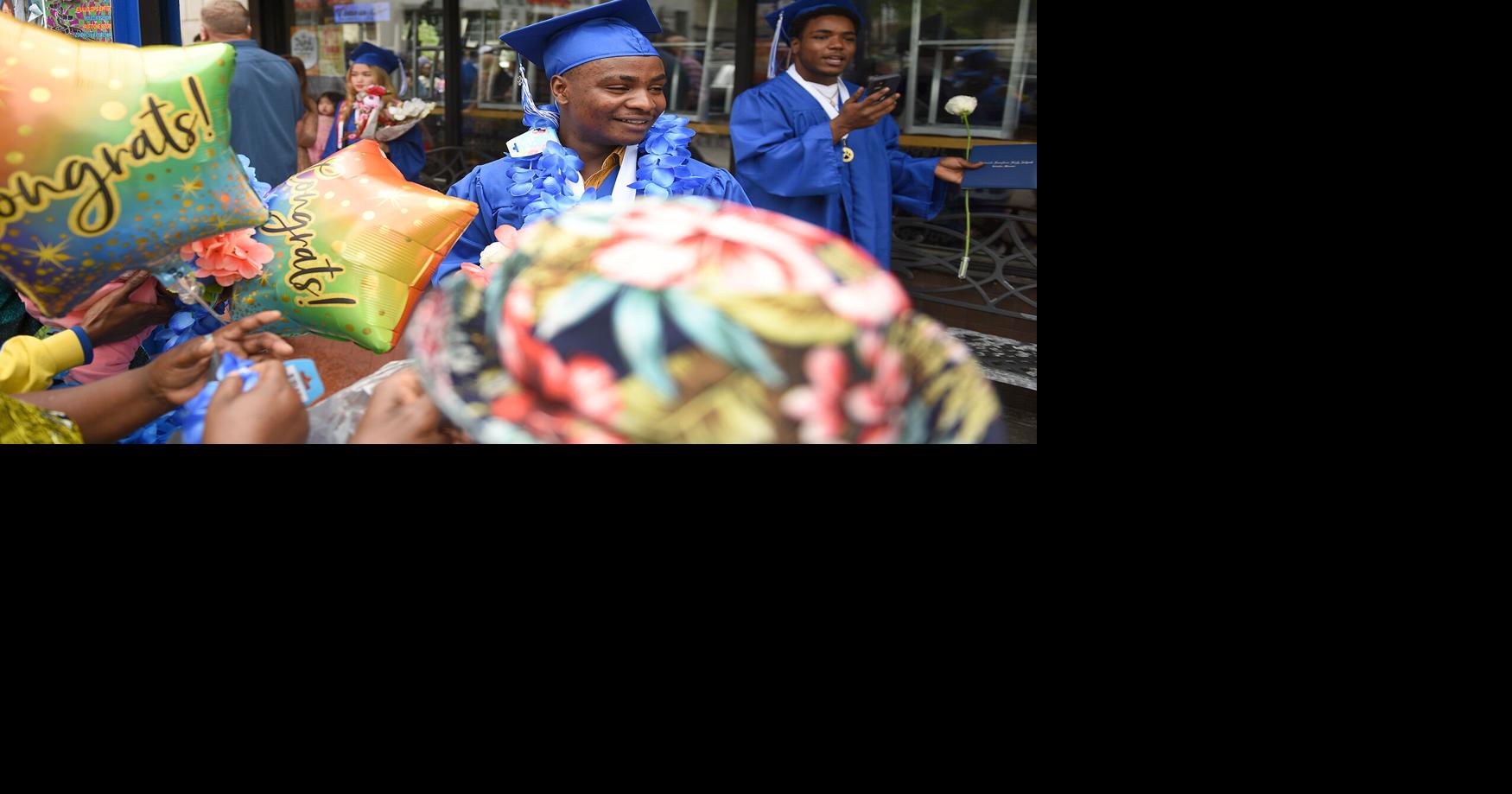 Shukuru Mateso receives celebratory balloons from his family (copy ...