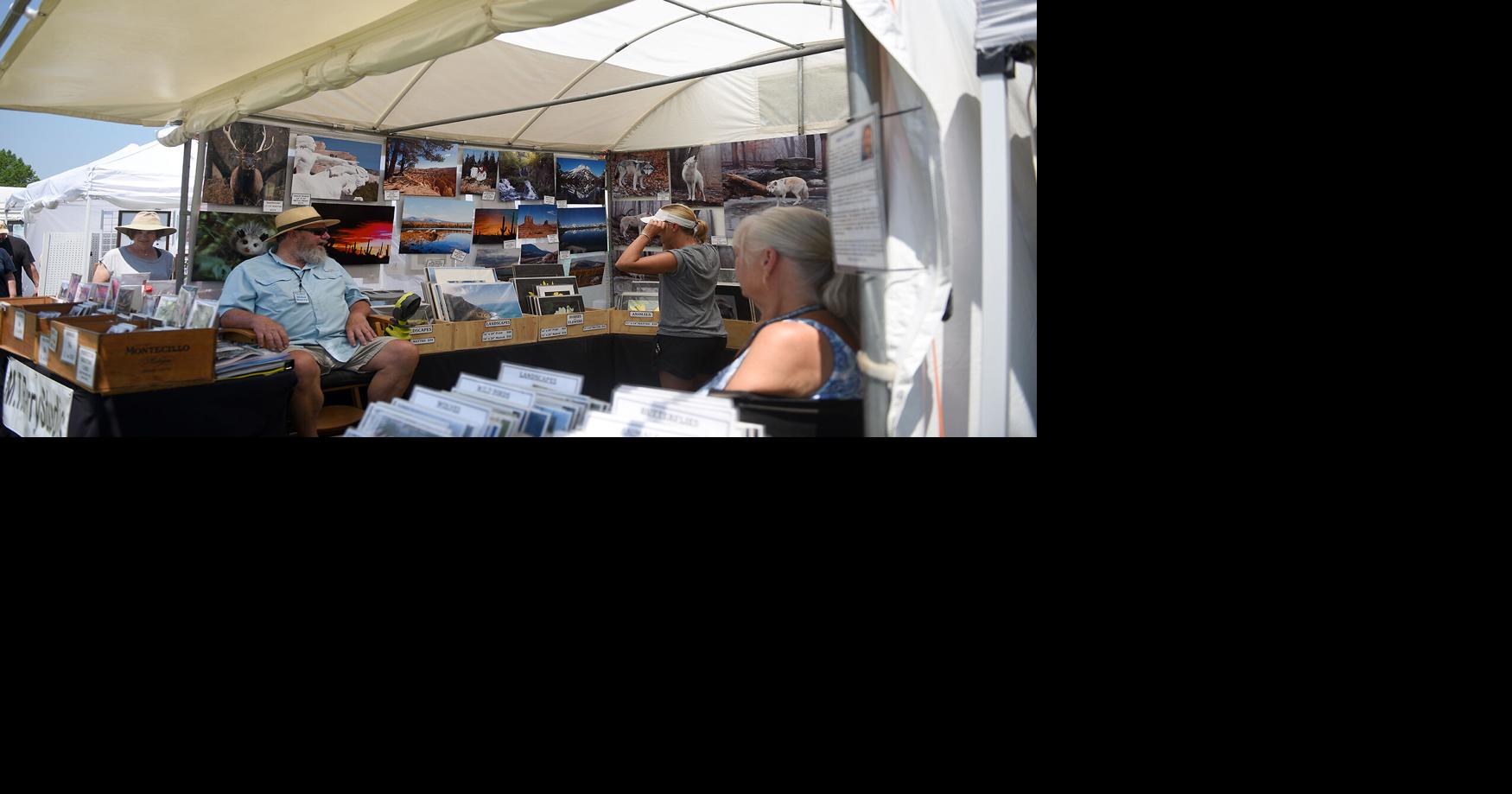 Mike Barry, left, sits inside his booth with his wife, Sue, right ...