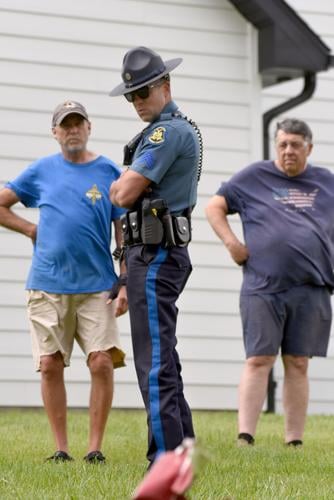 David Whitesides, left, and Mark Weichelt, right, look at plane debris ...