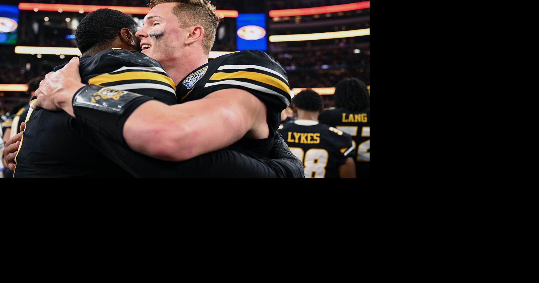 Quarterback Brady Cook and Defensive lineman Kristian Williams hug ...