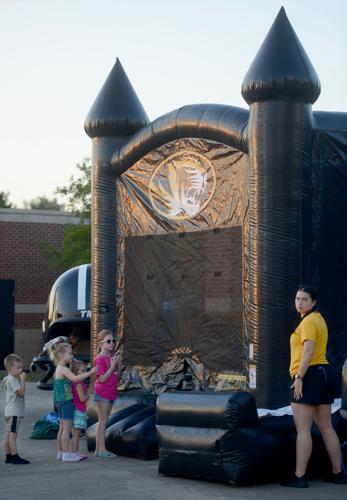 People gather for carnival activities during MU football's open ...