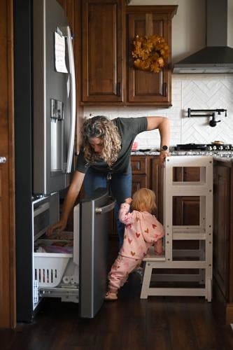 Emily Goyea-Furlong reaches over Ruby Furlong to get food out of the ...