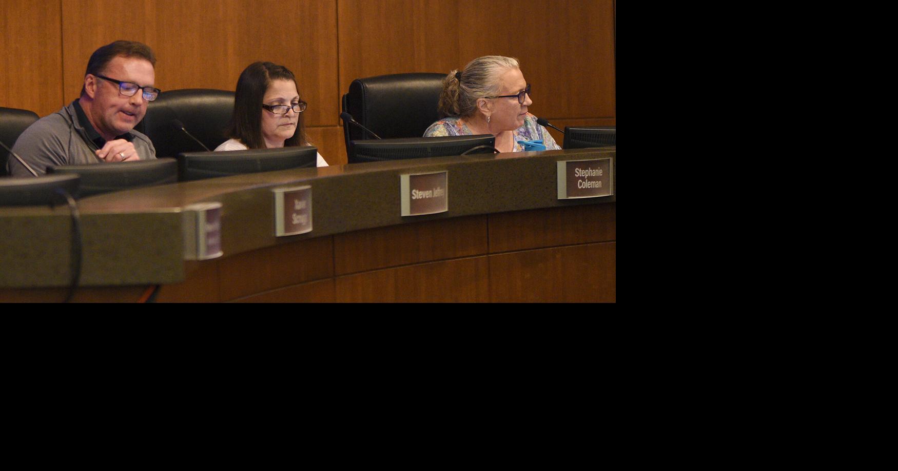 Stephanie Coleman, center, listens with Steven Jeffrey, left, and ...