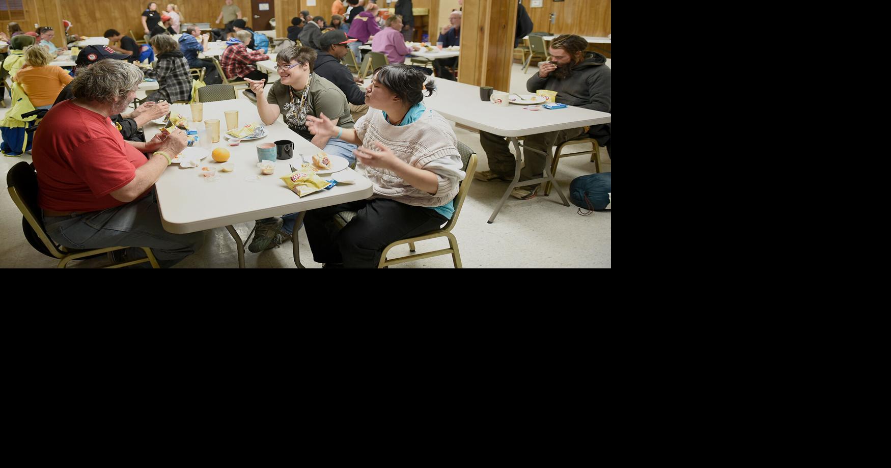 Ellen, center, sits with a group of her friends including her partner ...