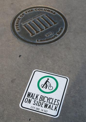 New stickers downtown remind cyclists to stick to the streets | Local ...
