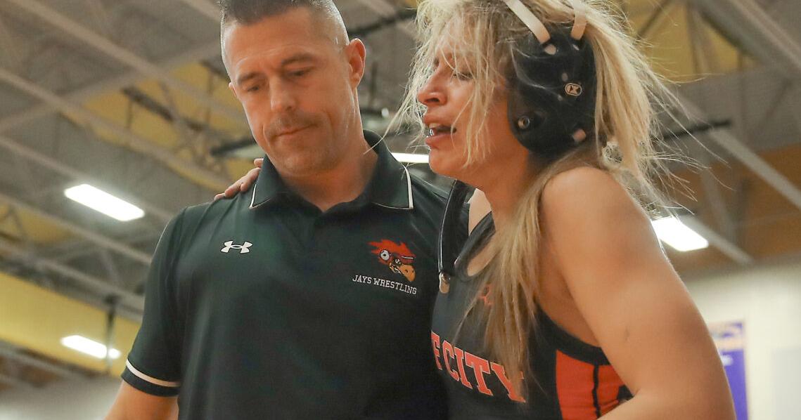 Jefferson City senior Kaylee Redcay, right, leans on her coach and ...