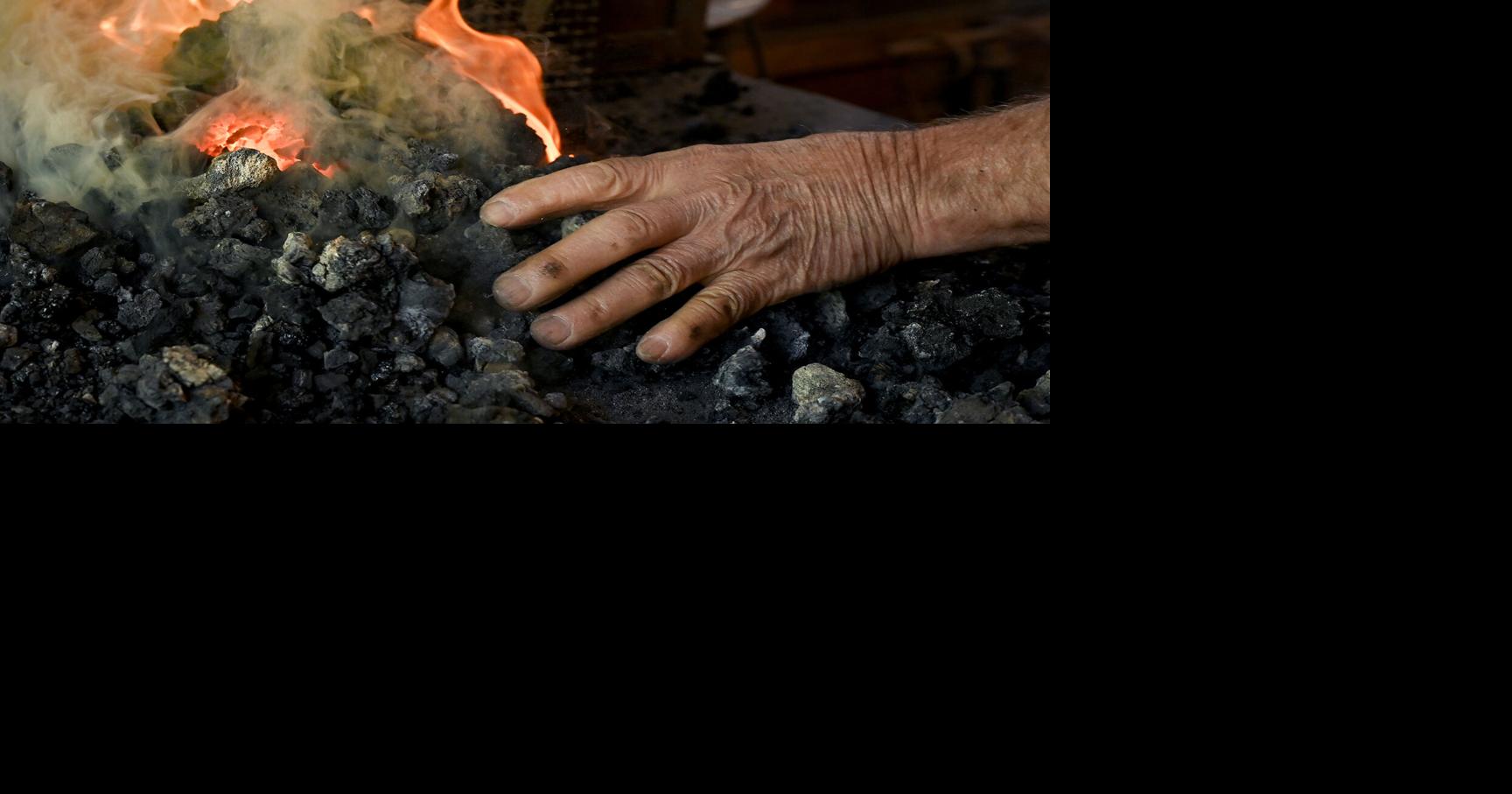 George B. Robb II pushes coals into the fire | Visuals ...