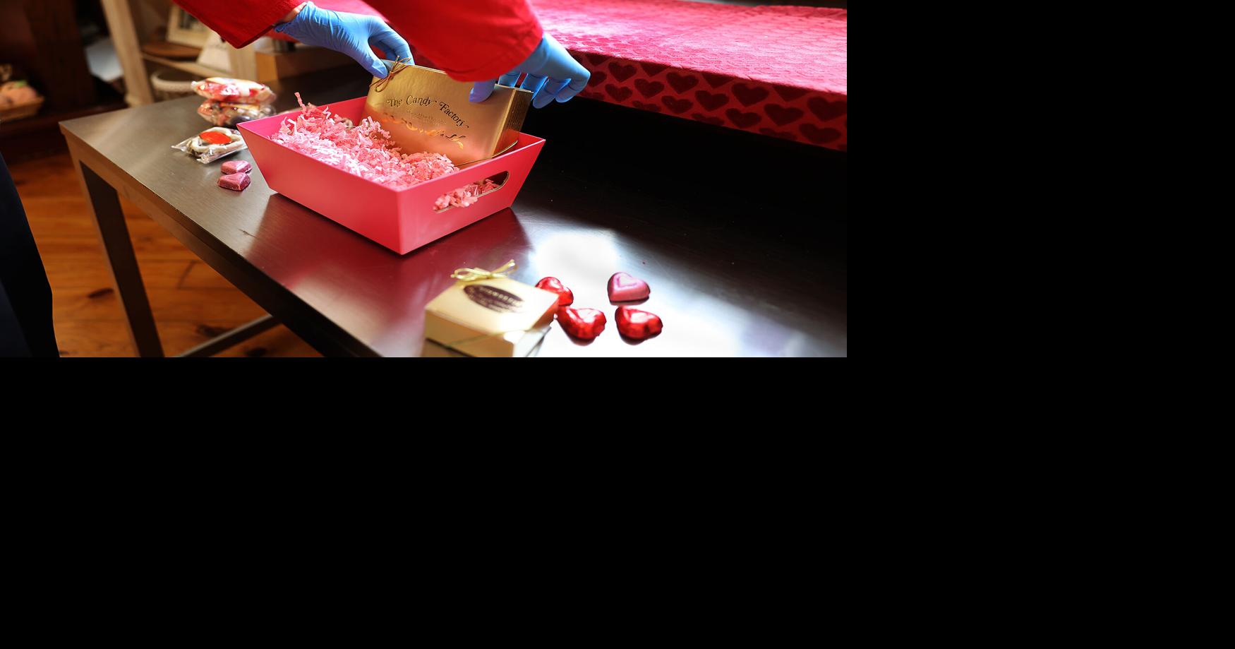 Allison Wright, a Candy Factory employee, demonstrates how to assemble ...